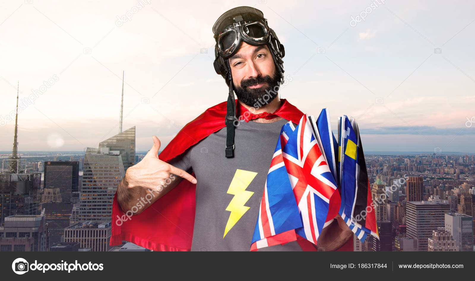 Superhero with a lot of flags proud of himself on unfocused city ...