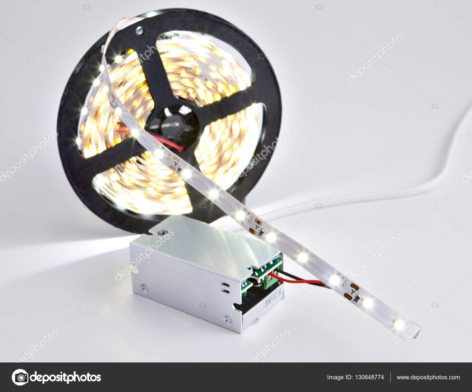 Spool of luminous LED strip light connected to Power Supply. — Stock ...