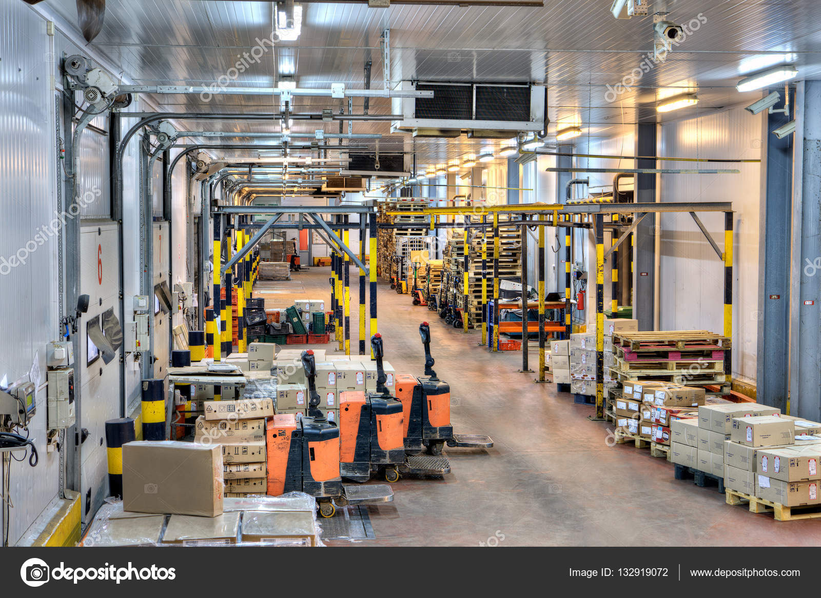 Loading dock in warehouse and several pedestrian pallet truck. – Stock ...