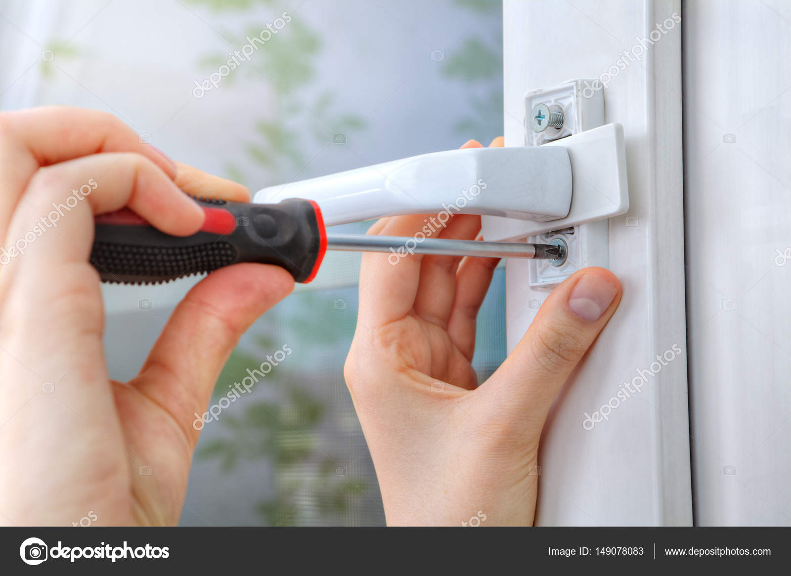 Screwing the screw of window handle on pvc window. Stock Photo by ...