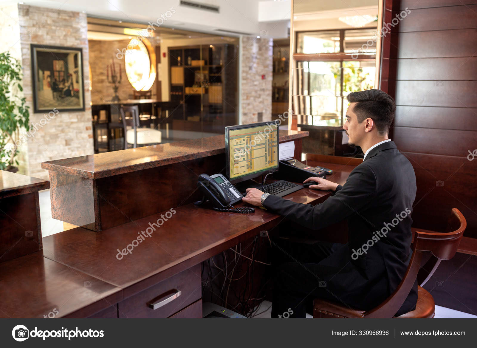 Front desk hotel receptionist working — Stock Photo © didesign #330966936