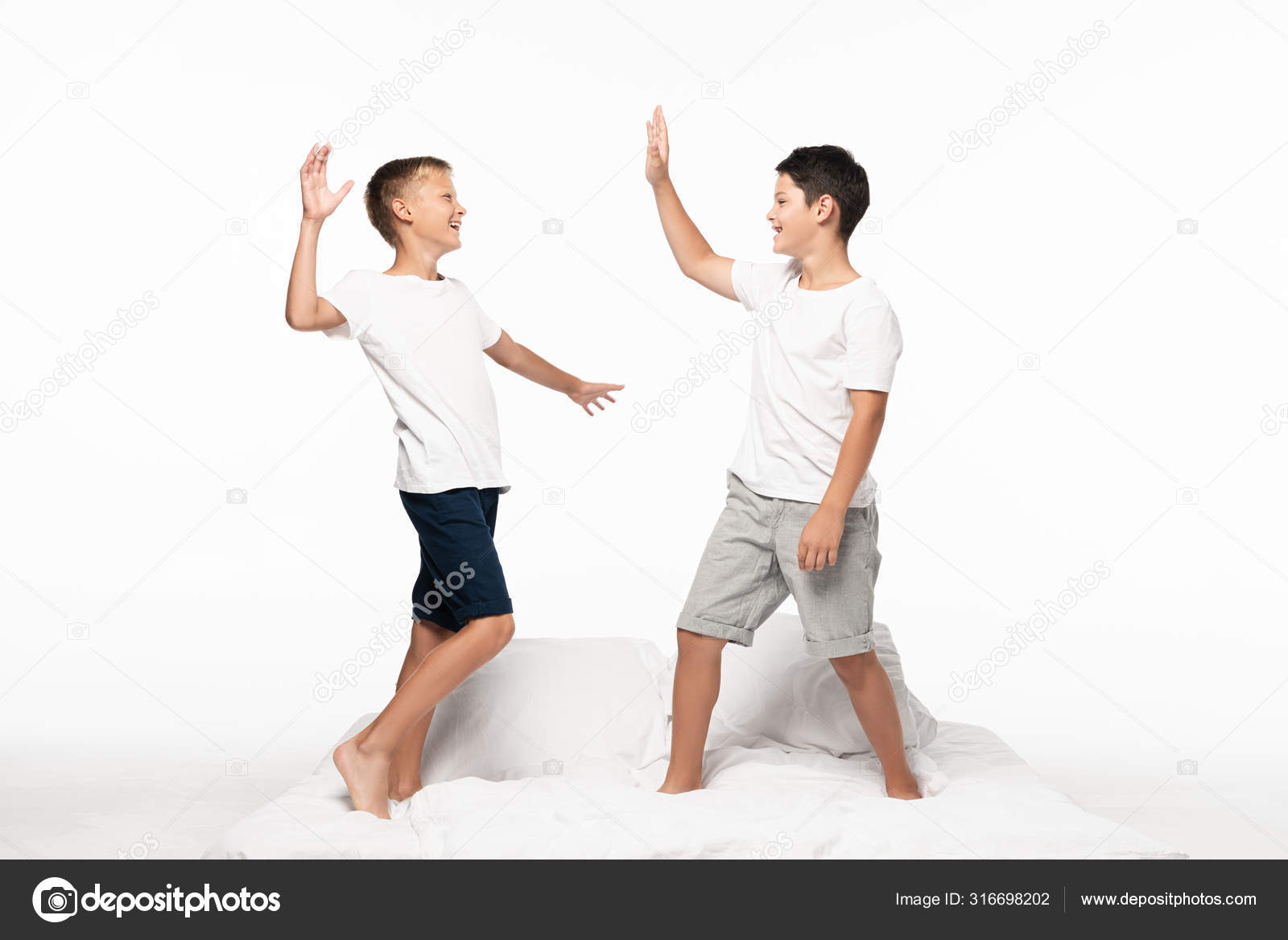 Cheerful Brothers Giving High Five While Standing Bed Isolated White ...