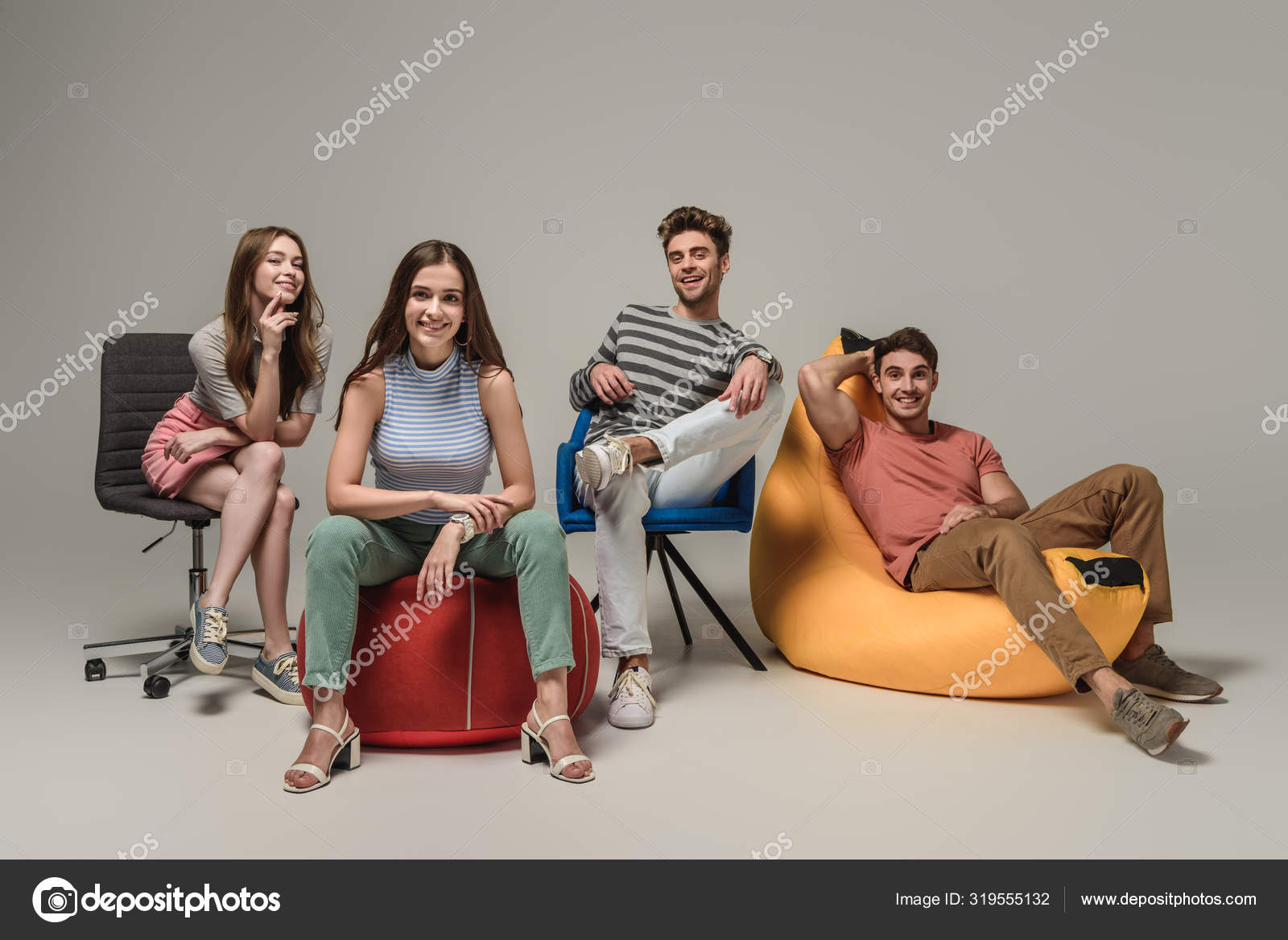 Smiling Friends Sitting Different Chairs Grey — Stock Photo ...