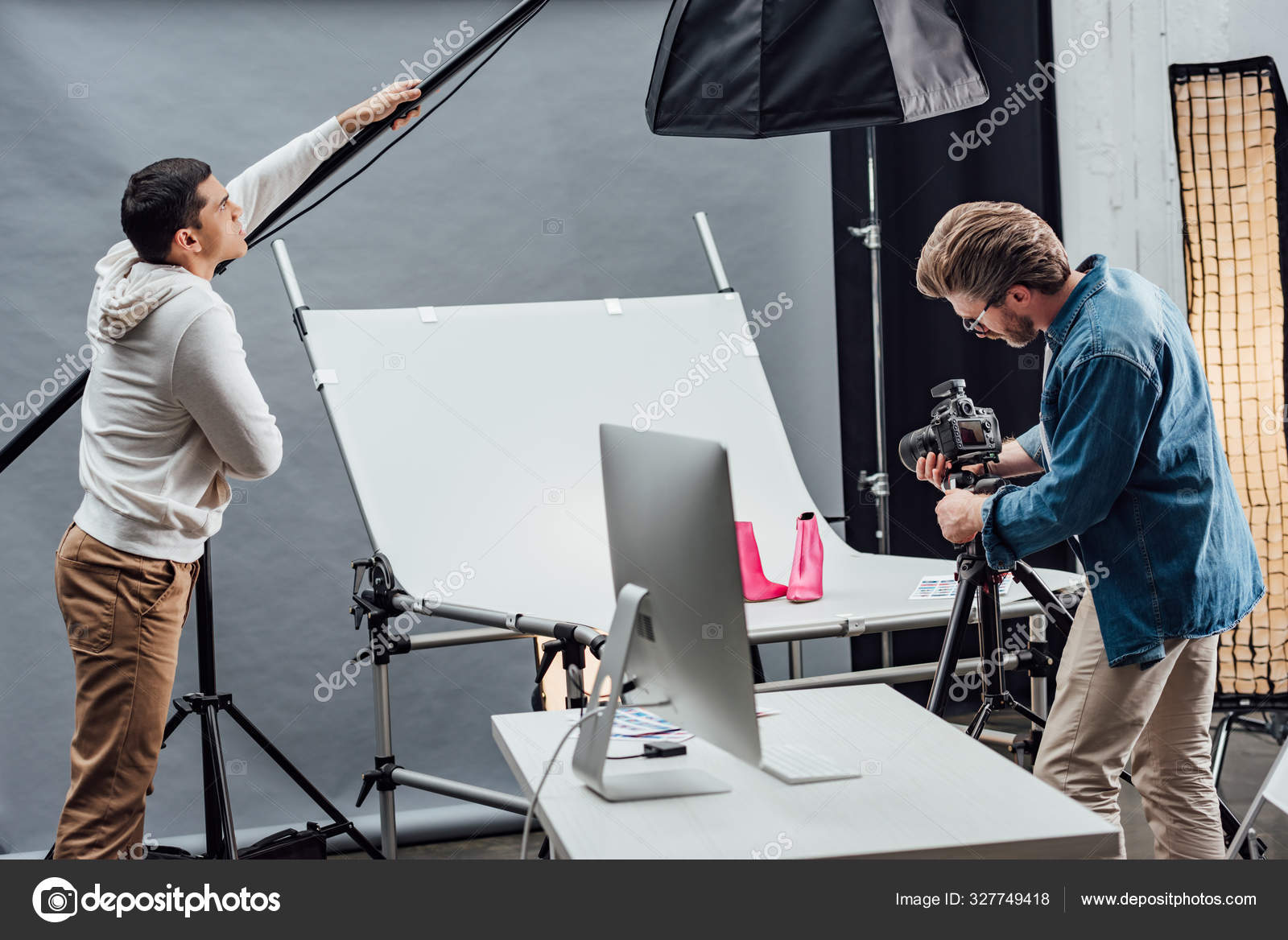 Handsome Assistant Touching Reflector While Photographer Photo Shooting ...