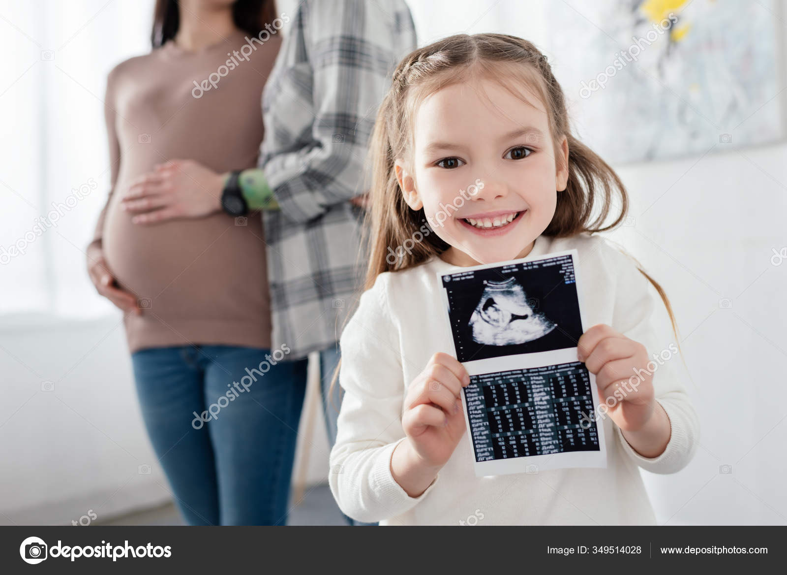 Selective Focus Smiling Kid Holding Ultrasound Scan Baby Mom Embracing ...