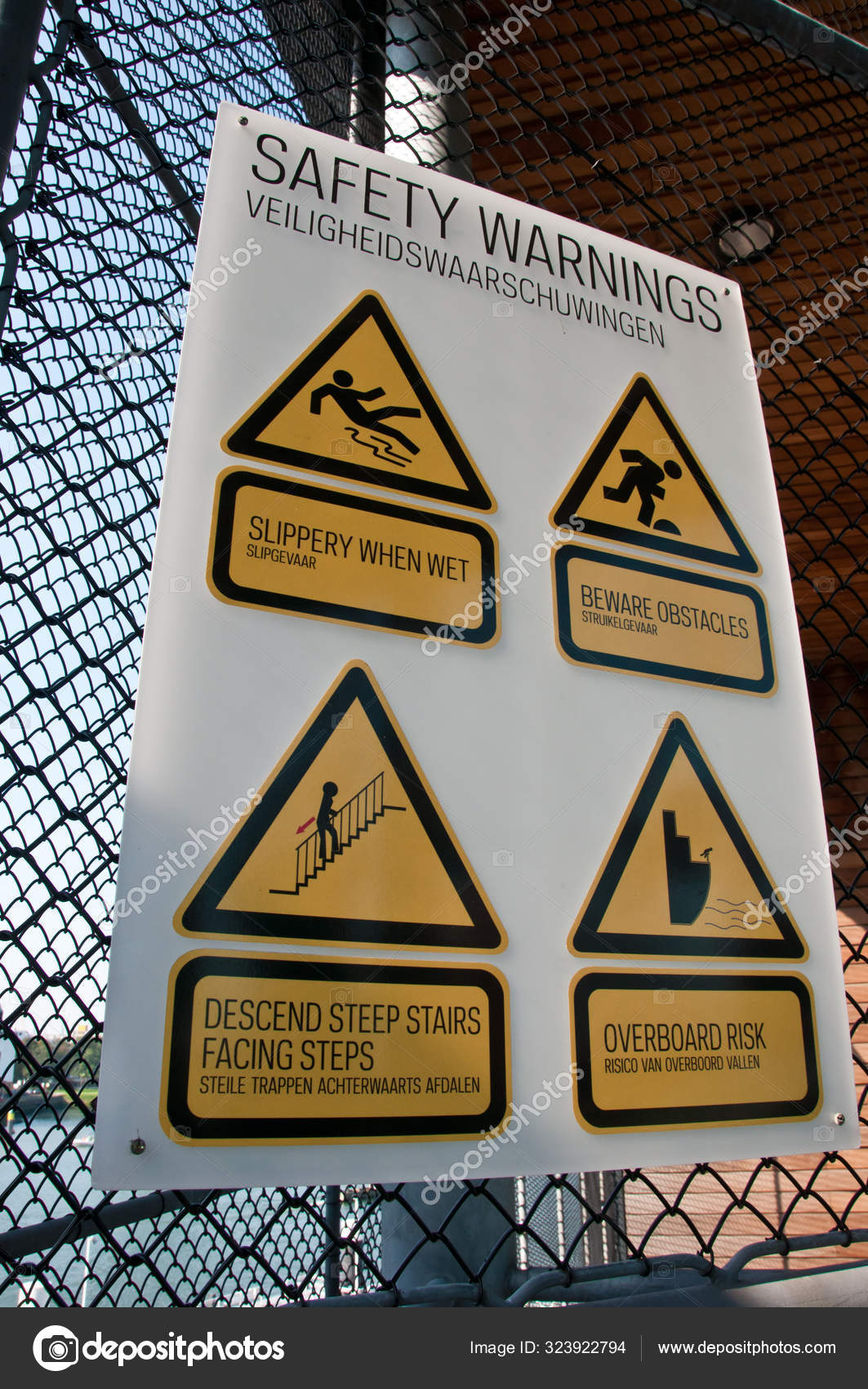 Danger Warning Signs Hanging Metal Grid Stock Photo by ©YAYImages 323922794