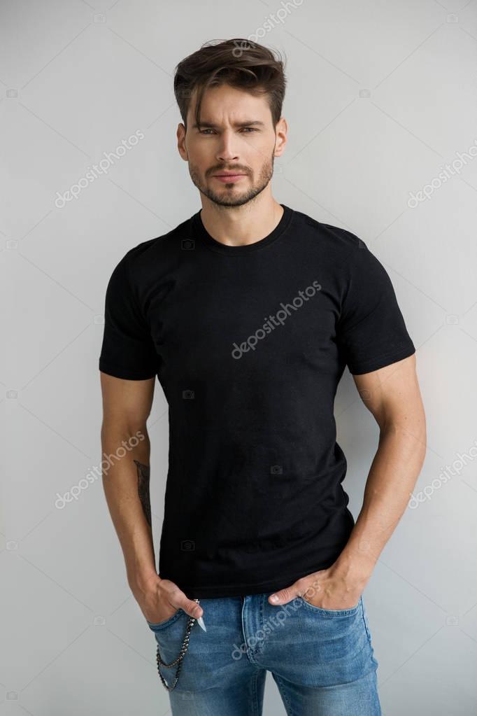 Man in black t-shirt looking at camera — Stock Photo © kiuikson #143415813