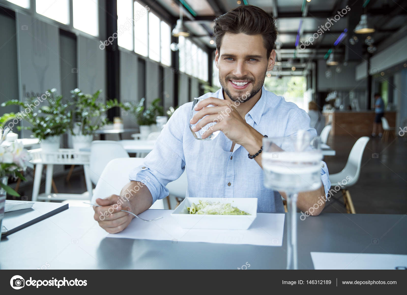 Handsome man eating pasta Stock Photo by ©kiuikson 146312189