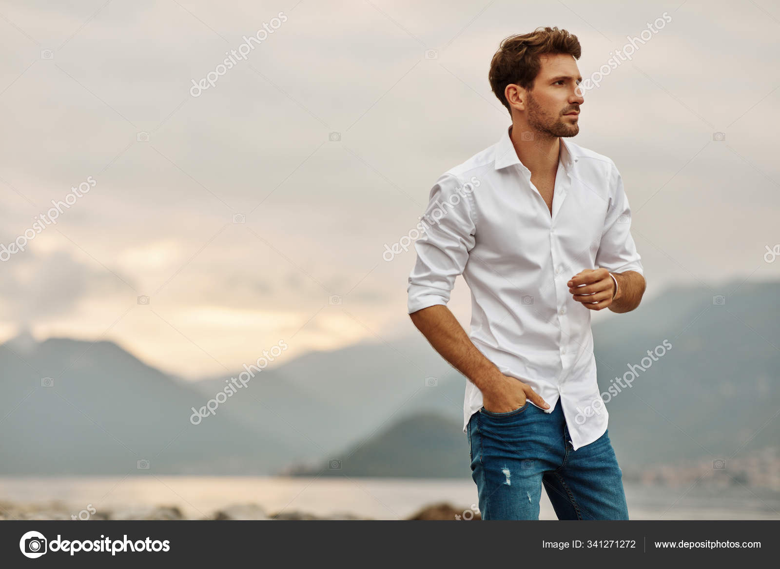 Pretty male model standing on a background of lake and mountains Stock ...