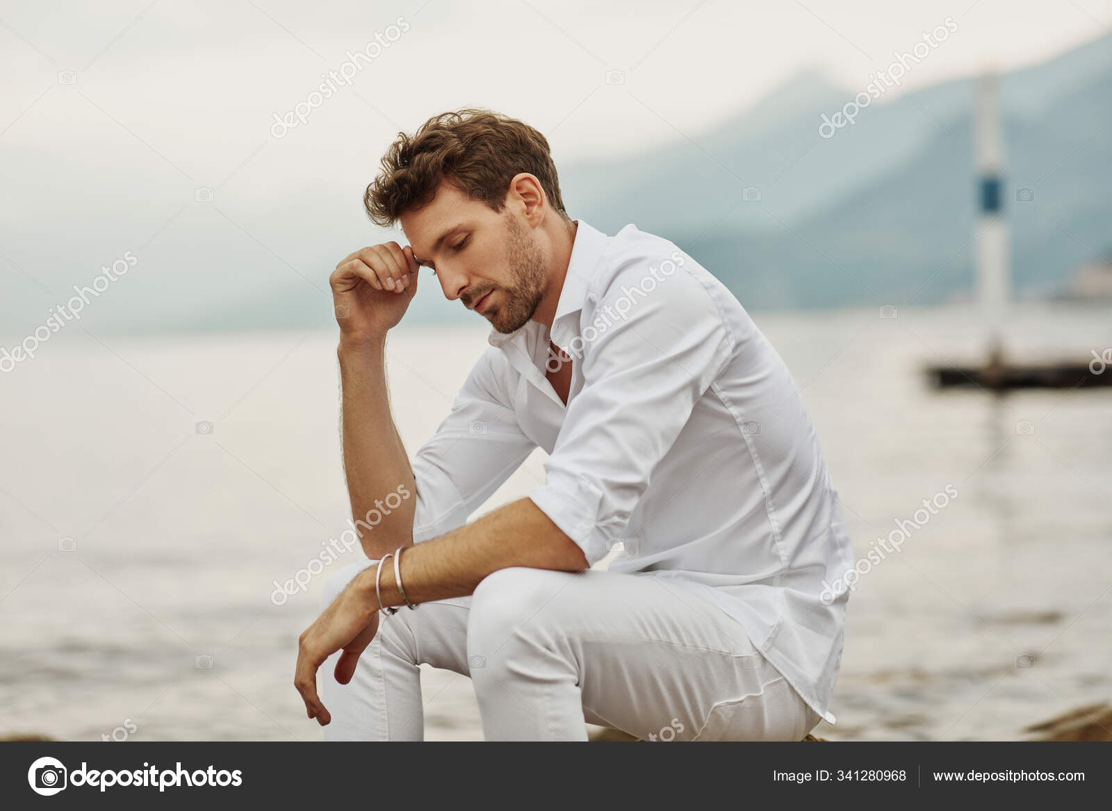 Handsome male model thinking outdoor on a background of lake and Stock ...