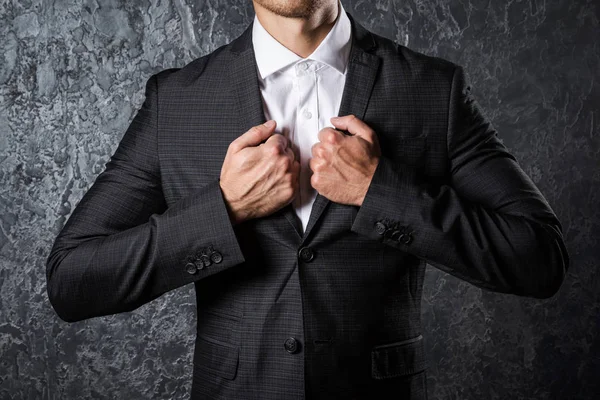 Man in suit against concrete wall Stock Photo by ©AY_PHOTO 119967576