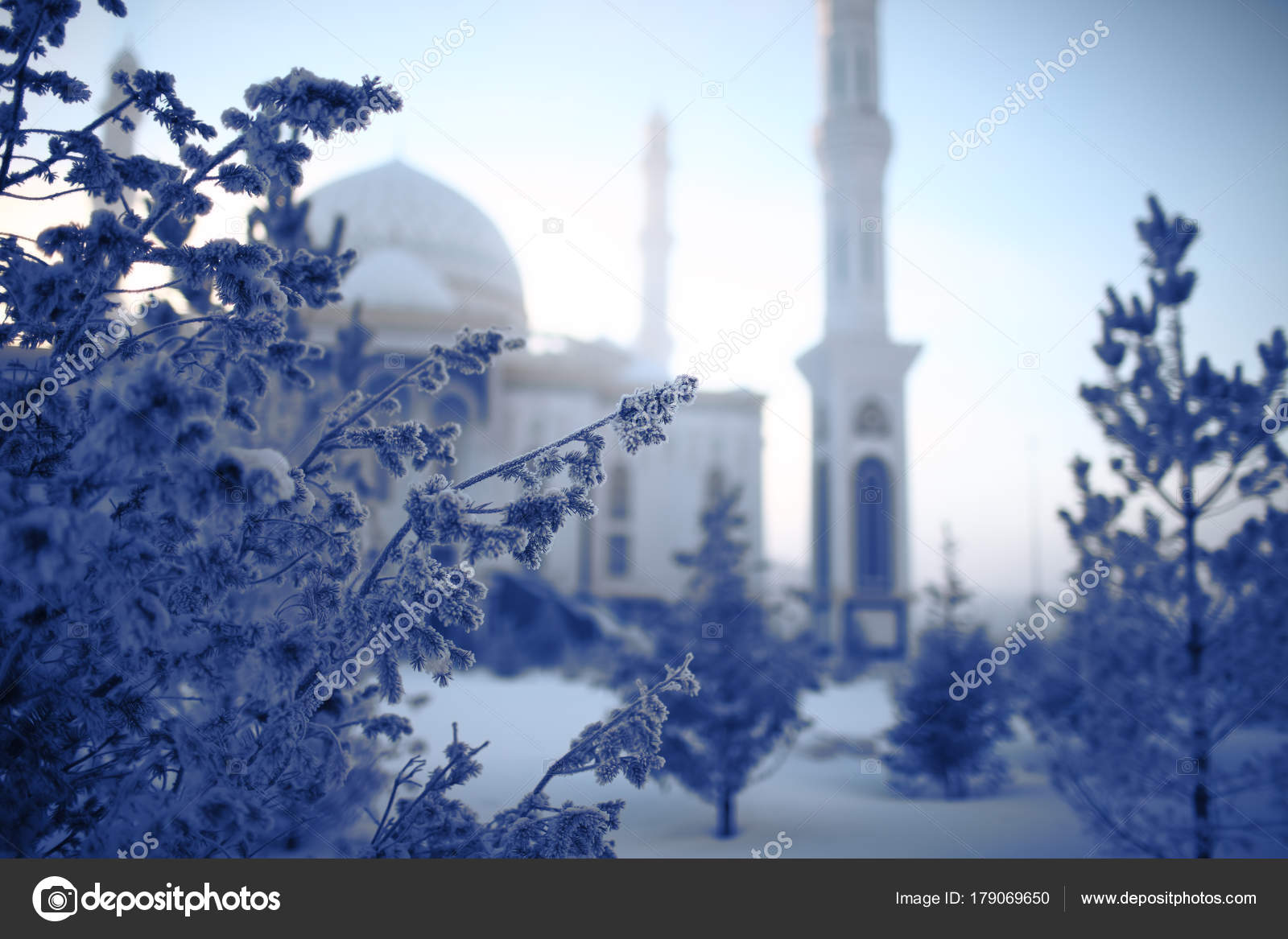 White mosque in the winter morning and the trees covered with ho ...