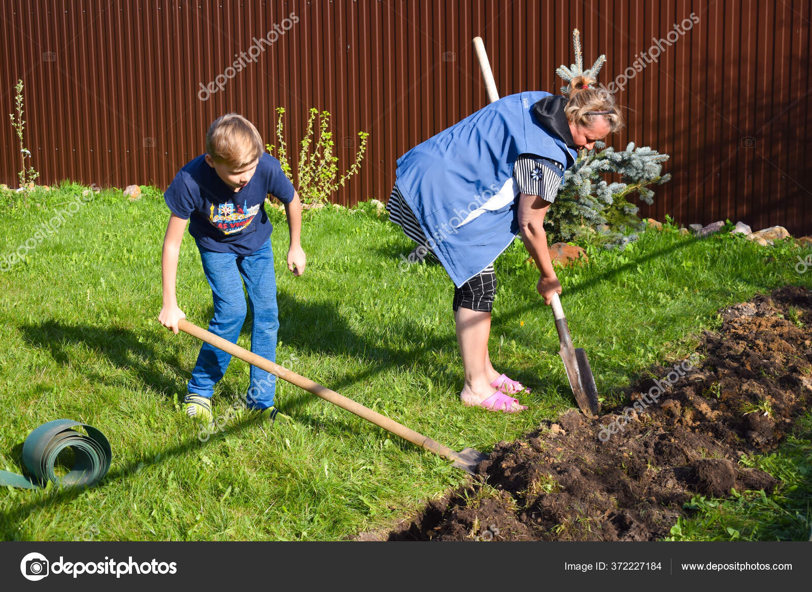 Grandmother and grandson digging the soil. Family together at the ...