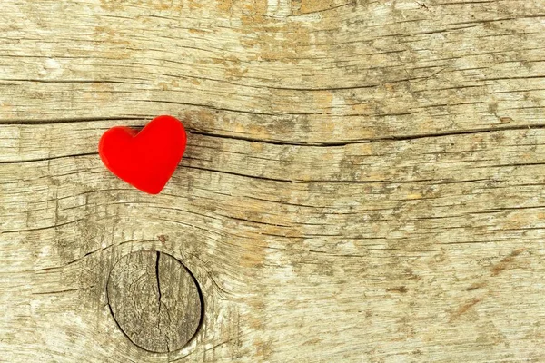 Red heart on a wooden background. The symbol of love. The memory of ...