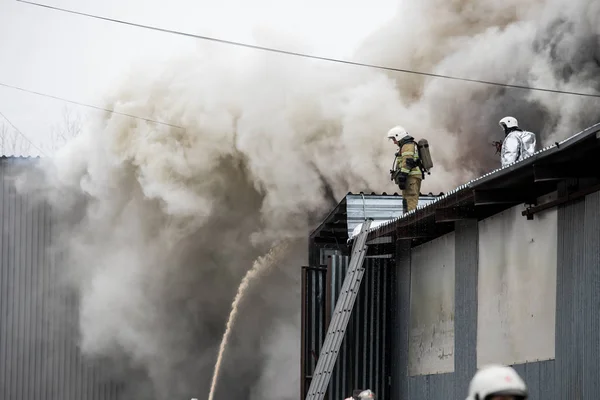 fire at work, storage facilities are burning, firemen are working ...
