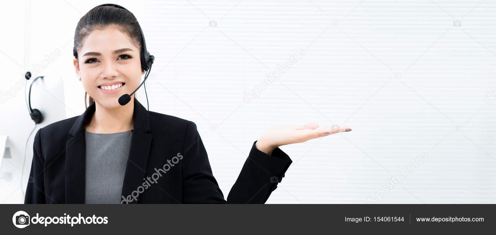 Asian businesswoman as an operator in call center making open hand ...