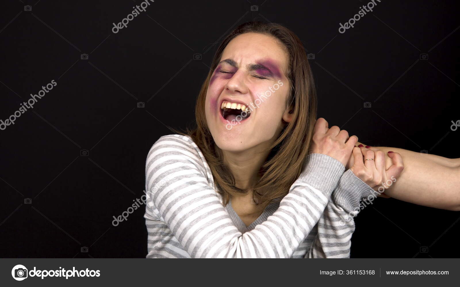 The man grabbed the young woman by the hair. A woman with bruises on ...