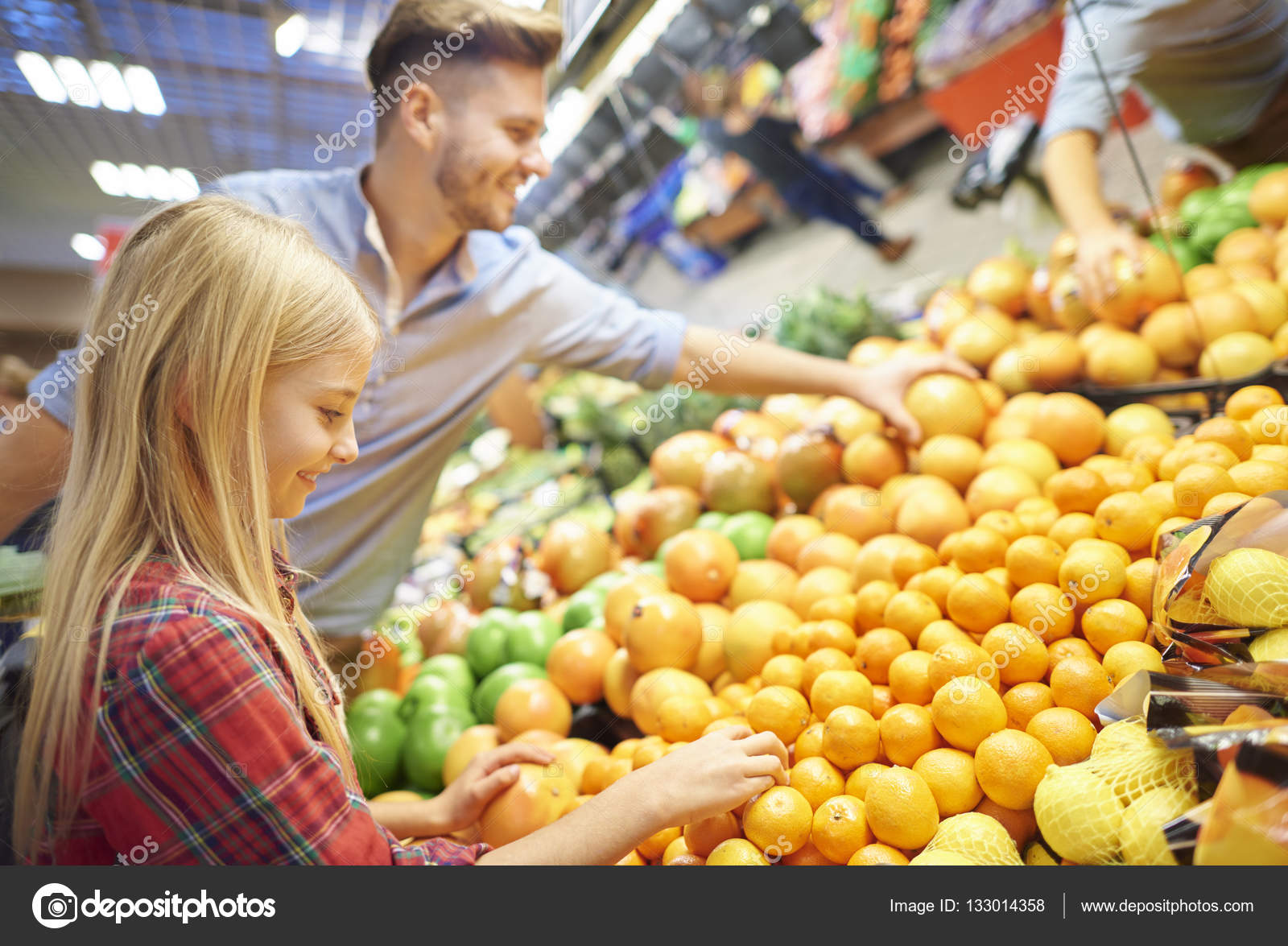 Daddy and daughter comparing fruits Stock Photo by ©gpointstudio 133014358