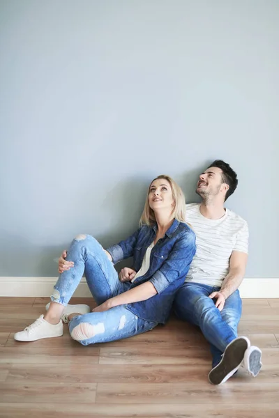 Couple sitting on floor and hugging Stock Photo by ©gpointstudio 136225564