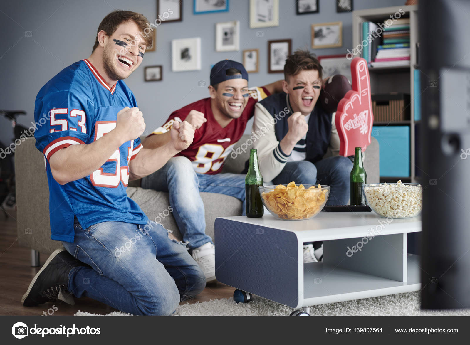 Friends cheering for team — Stock Photo © gpointstudio #139807564