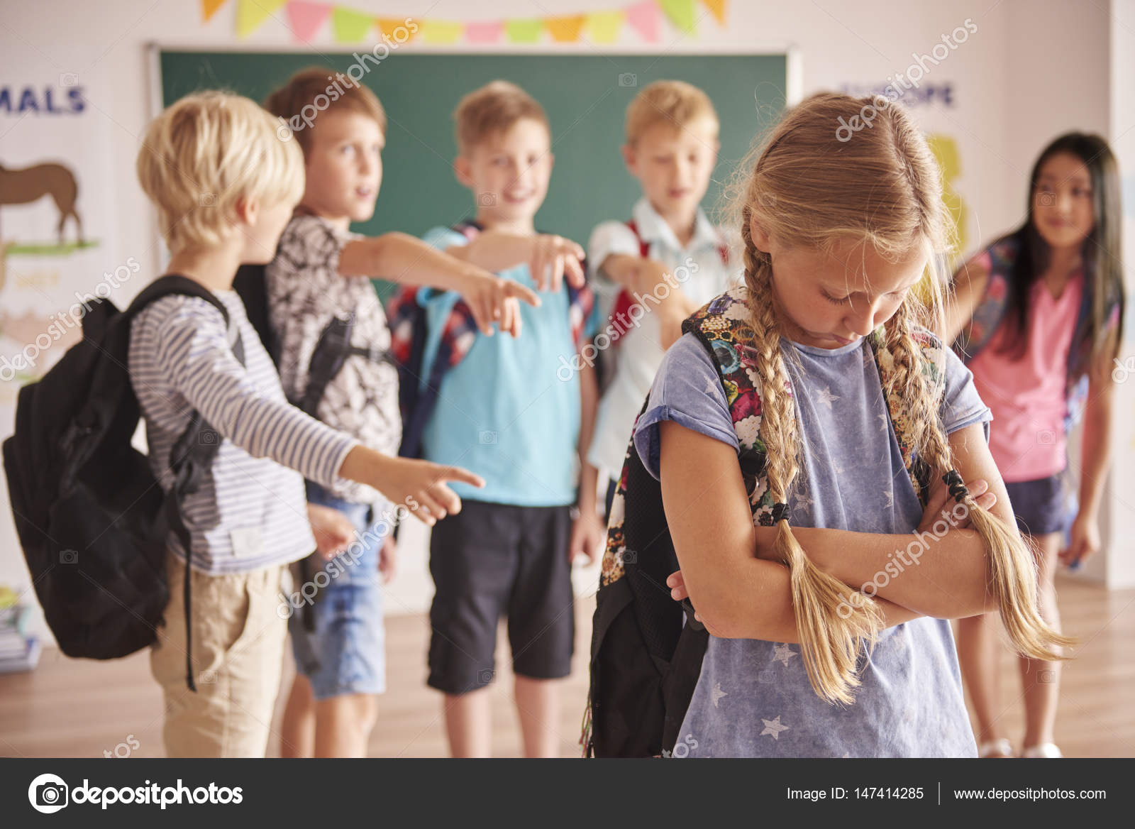 Girl standing sad in front of classmates — Stock Photo © gpointstudio ...