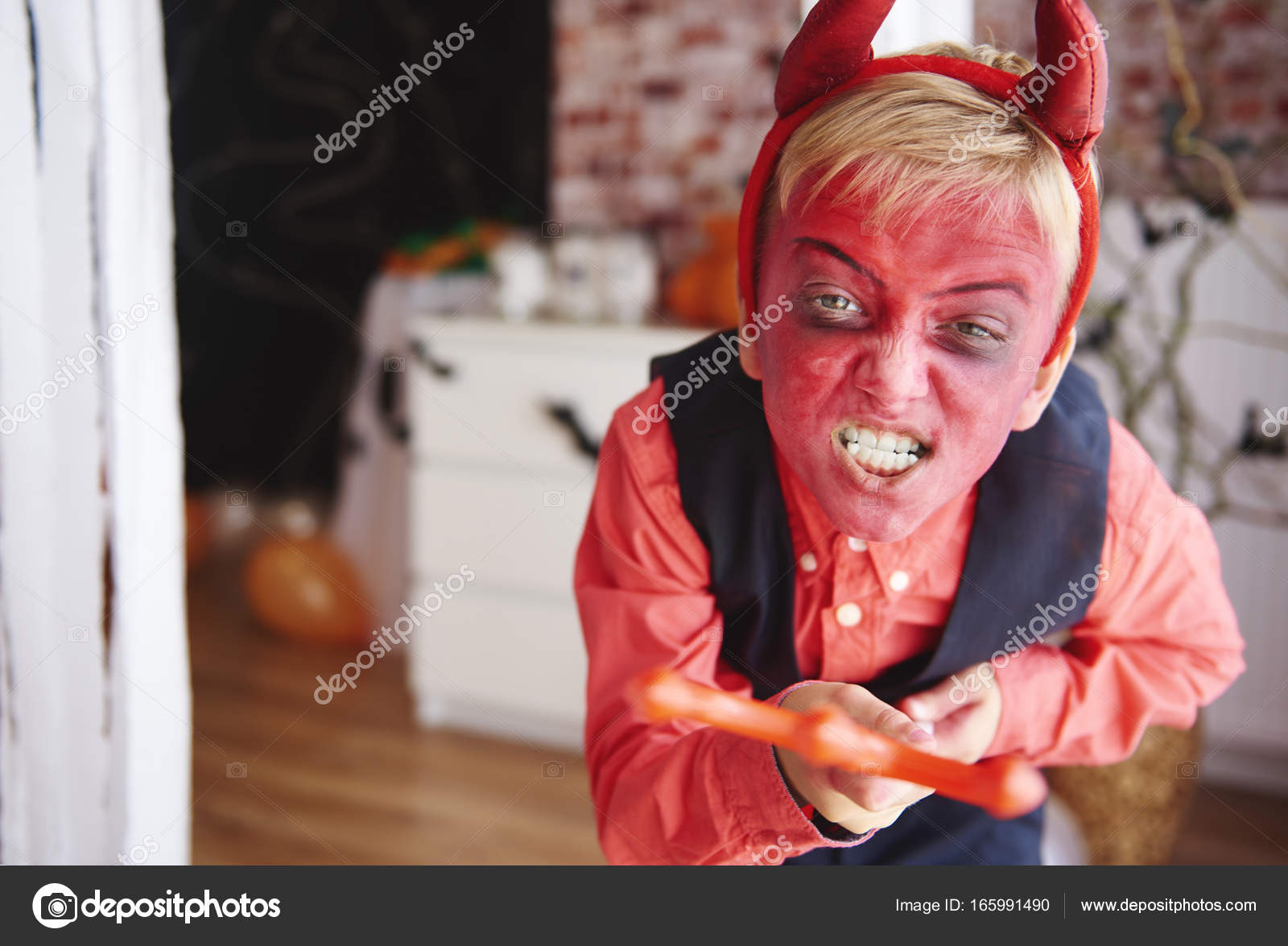 Boy in devil costume trying to scare people Stock Photo by ...