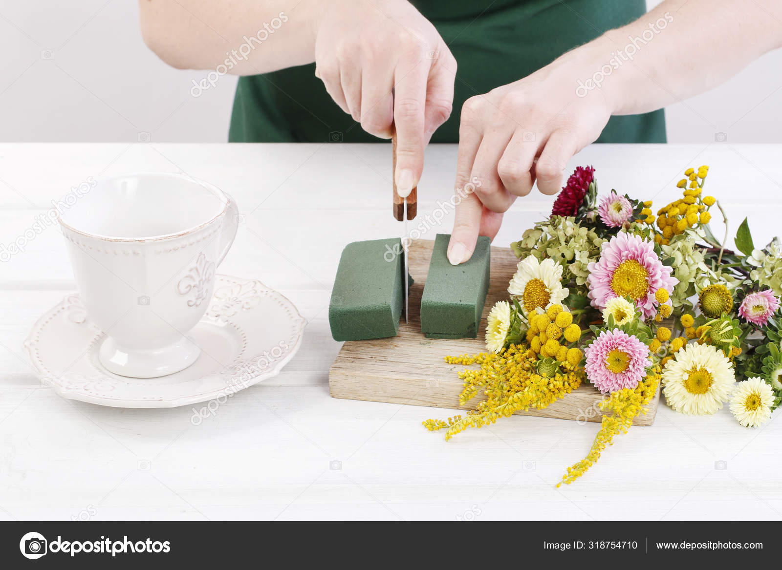 Woman shows how to make floral arrangement with summer flowers i ... Woman shows how to make floral arrangement with summer flowers i ...