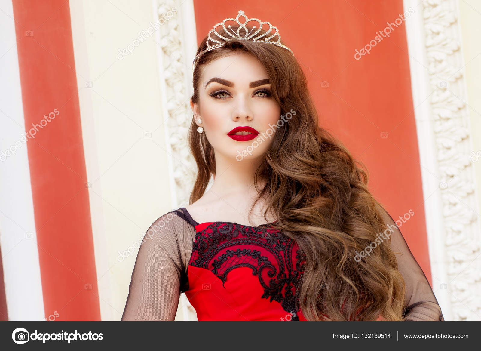 Beautiful young girl in a red evening long dress. The beauty queen in a red dress — Stock Photo ...