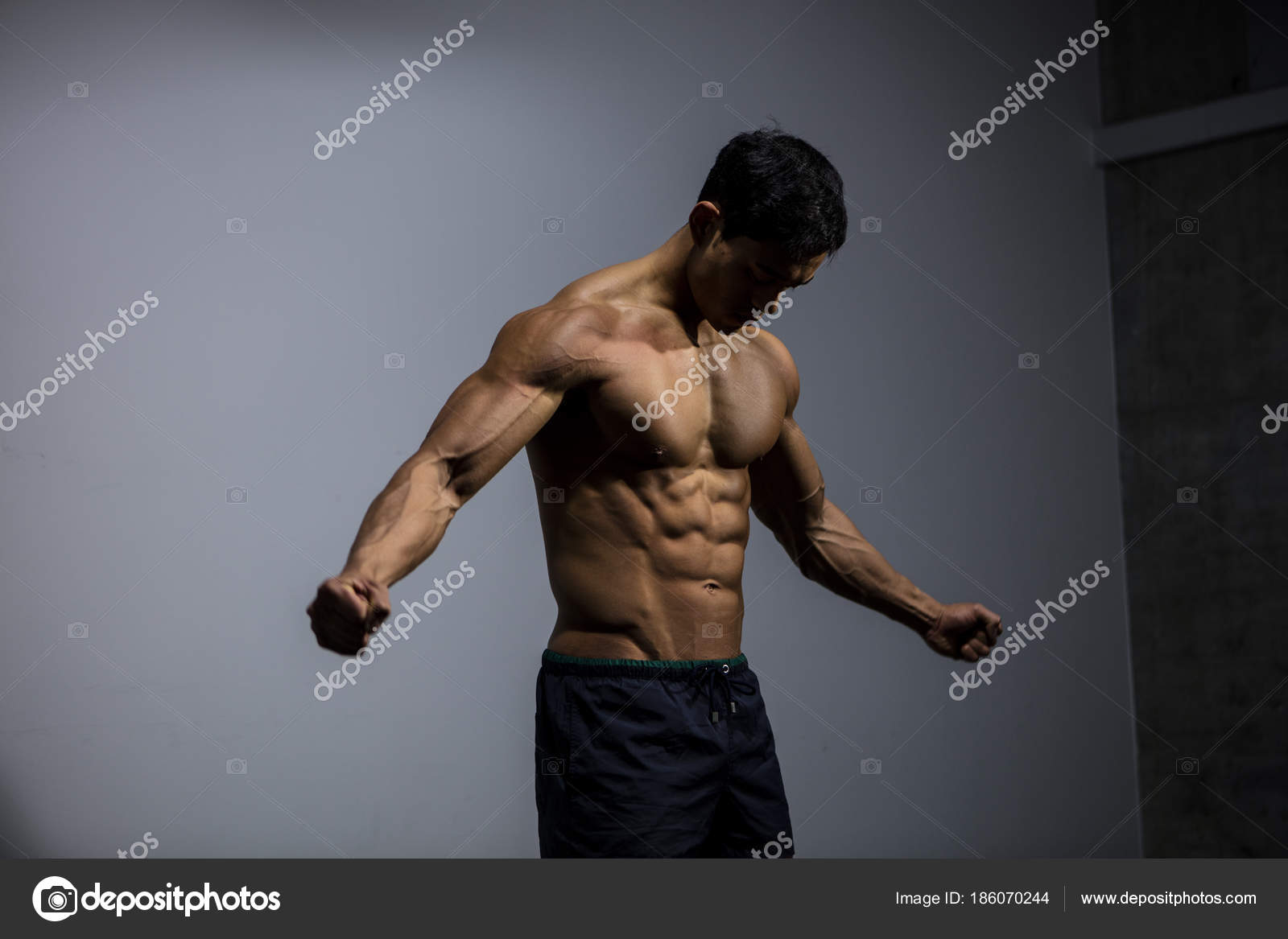 Asian Fitness Model Flexing Muscles — Stock Photo © nektarstock #186070244