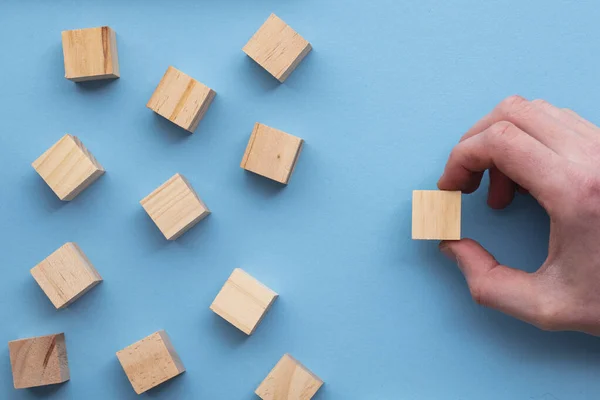 Hand choosing a wooden block from a set. Business choice concept Stock ...
