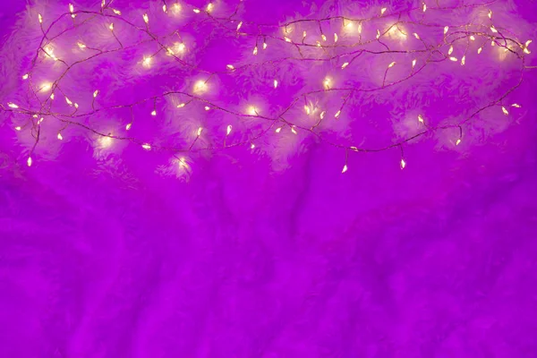 Christmas lights over a bright violet fluffy background - Stock Image ...