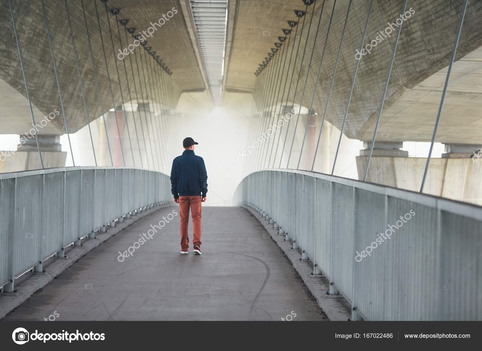 Man under highway brige in mysterious morning fog — Stock Photo ...