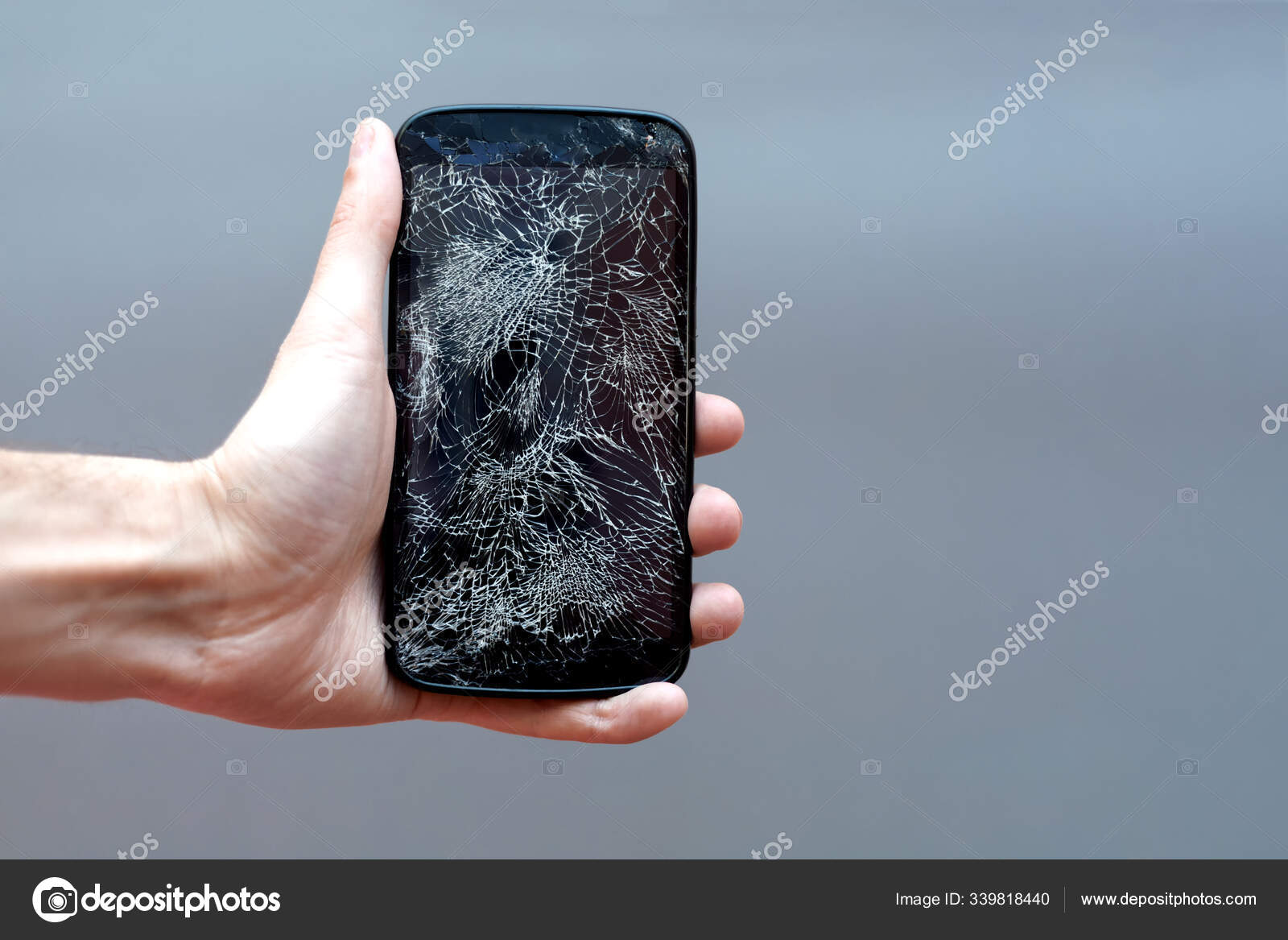 Smartphone with broken screen in hand on grey background. Stock Photo ...