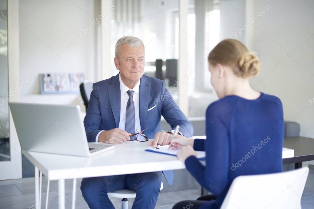 Agent consulting with her young client Stock Photo by ©Sepy 129562182