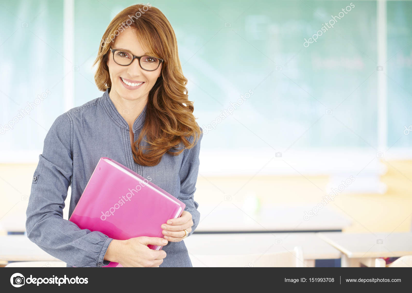 Teacher holding paper sheets Stock Photo by ©Sepy 151993708