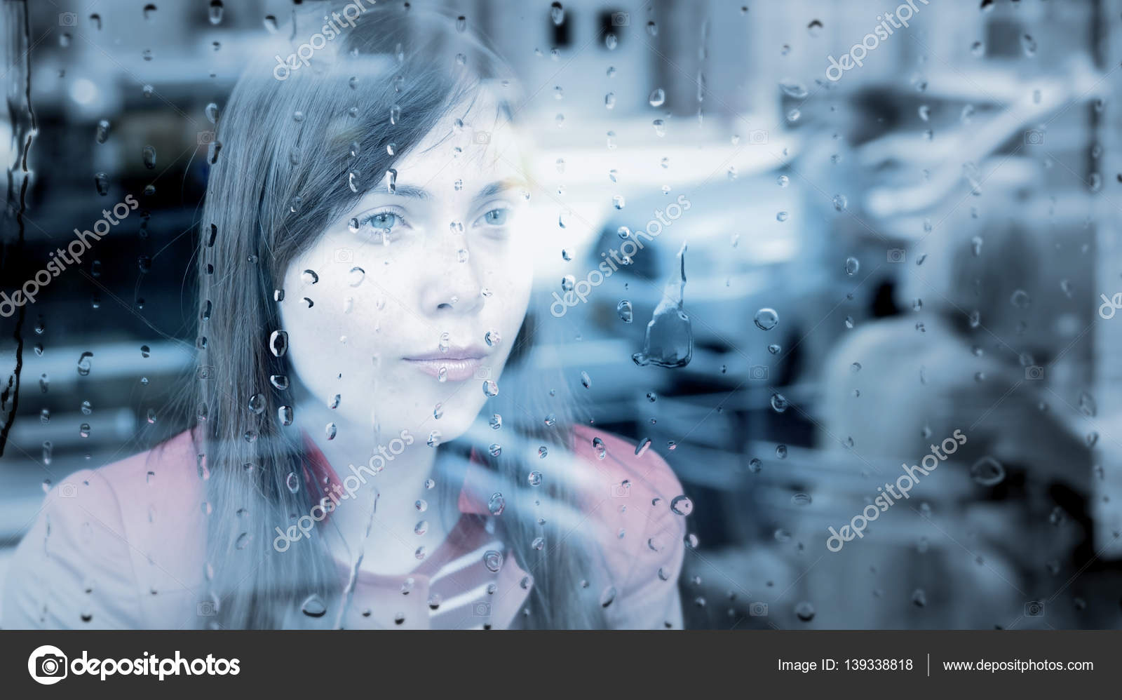 Woman behind window with raindrops Stock Photo by ©stockmedia 139338818
