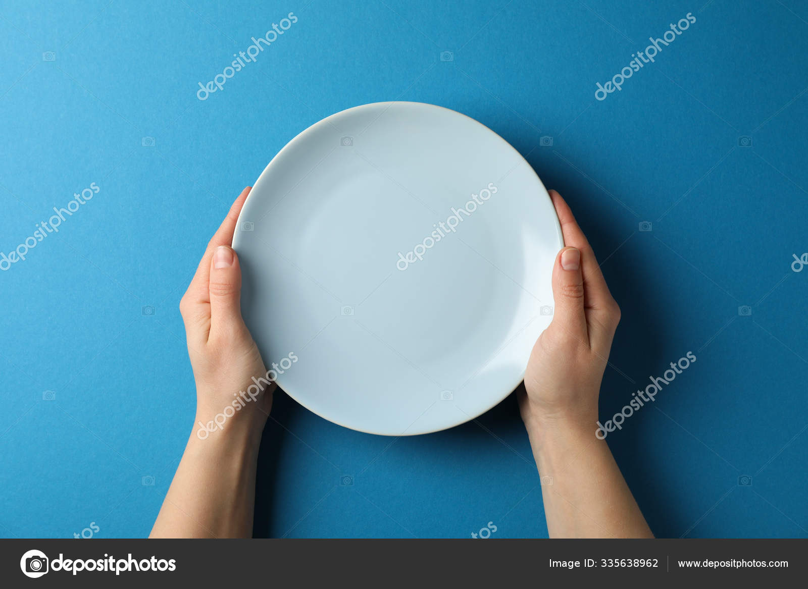 Female hands hold plate on blue background, top view — Stock Photo ...