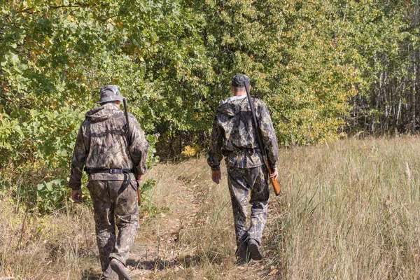 Hunters men with weapons go hunting Stock Photo by ©insTar 316541450