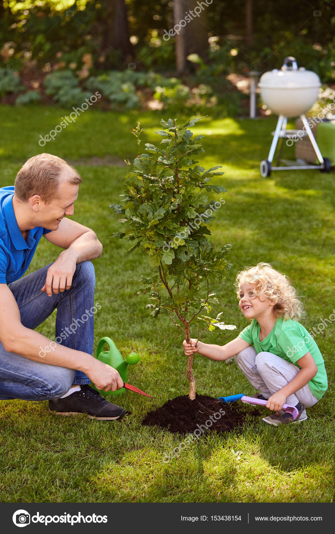 Boy holding a small tree Stock Photo by ©photographee.eu 153438154