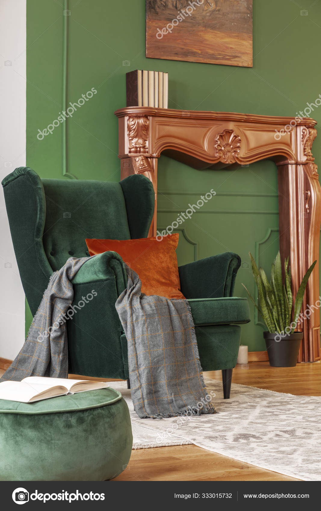 Emerald green wing back chair with orange pillow in luxury living room ...