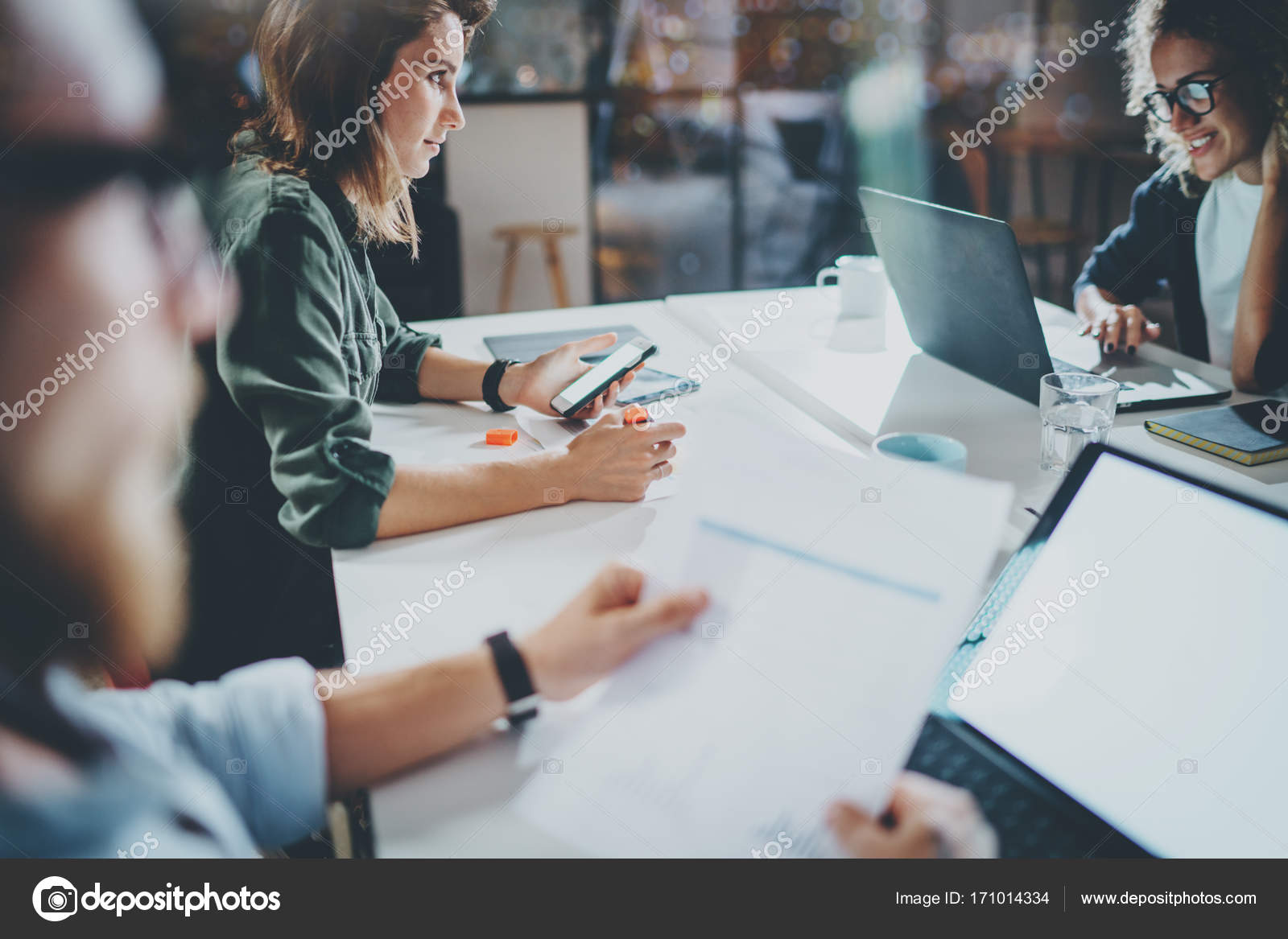 Group of young coworkers work together modern coworking studio at night ...