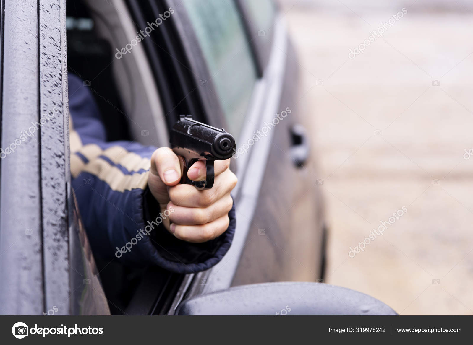 Man with a gun driving a car, male hand with a gun — Stock Photo ...