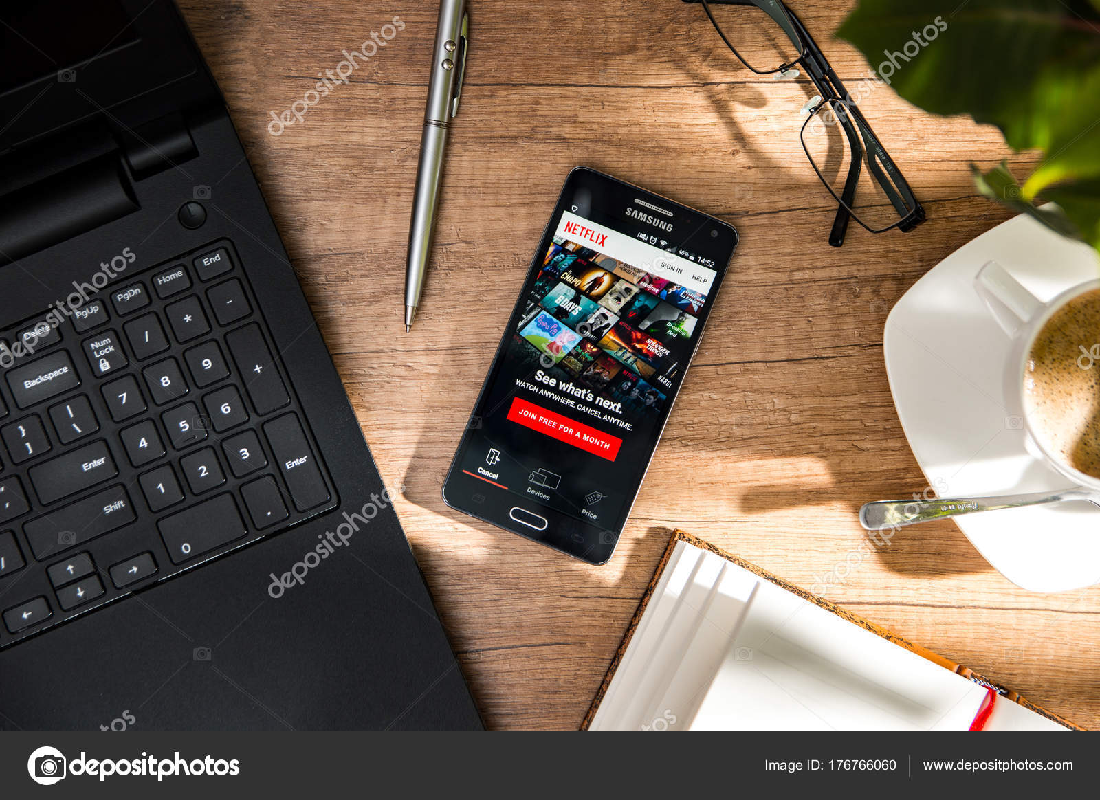 Samsung A5 is laying on the desk with Netflix application on screen ...