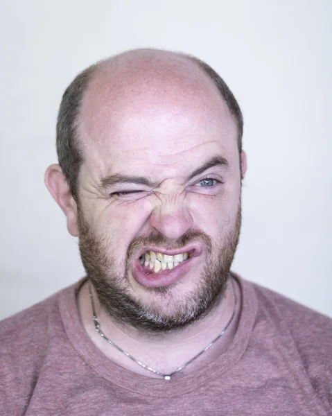 Close-up of Caucasian man face making facial expressions that mean ...