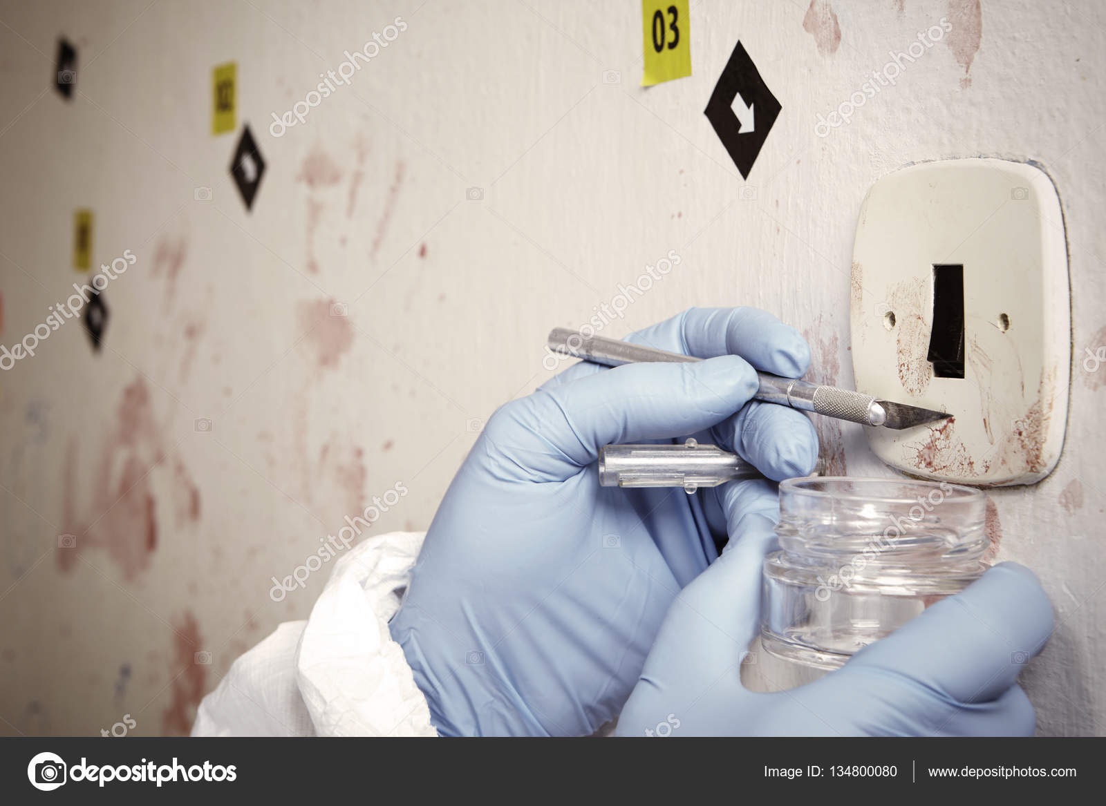 Scraping of blood stains for evidence by technician on location Stock ...