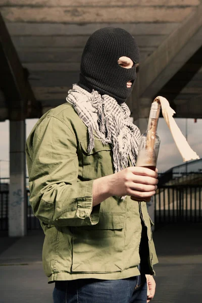 Anarchist in balaclava holding molotov cocktail bottle bomb — Stock ...