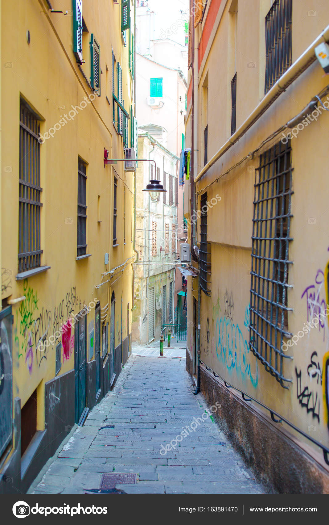 Old beautiful empty narrow streets in small city of Genova in Italy ⬇ ...