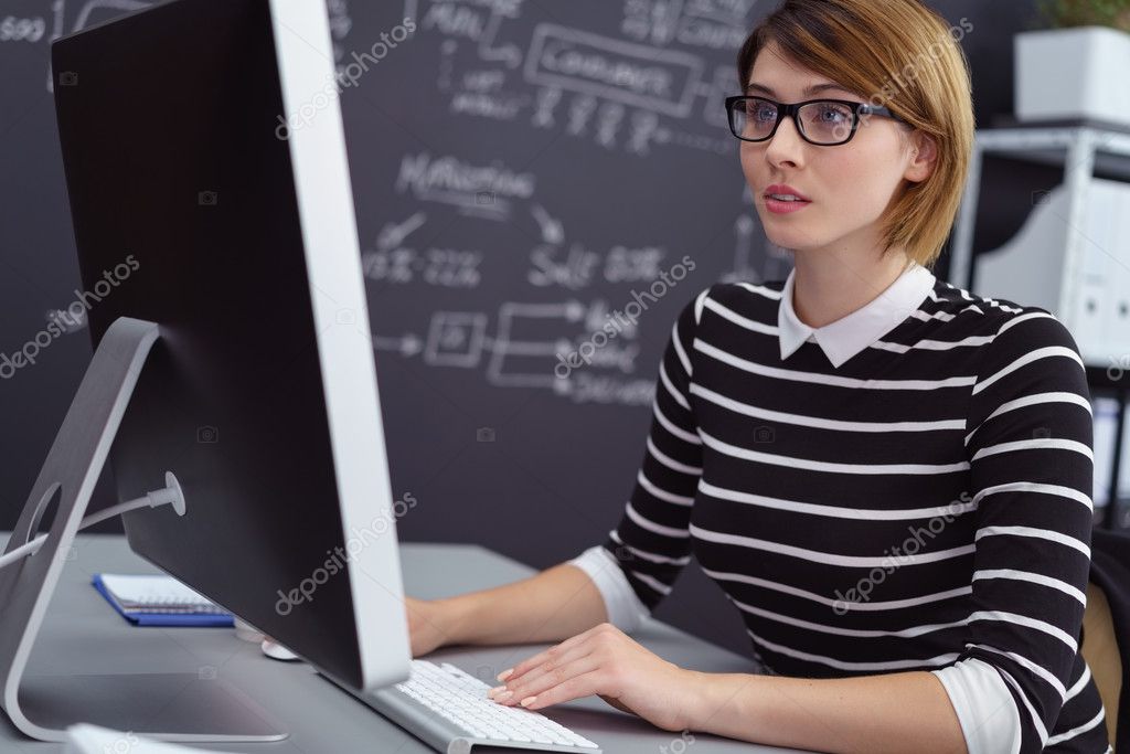 Computer scientist seated at desk in office Stock Photo by ©racorn ...
