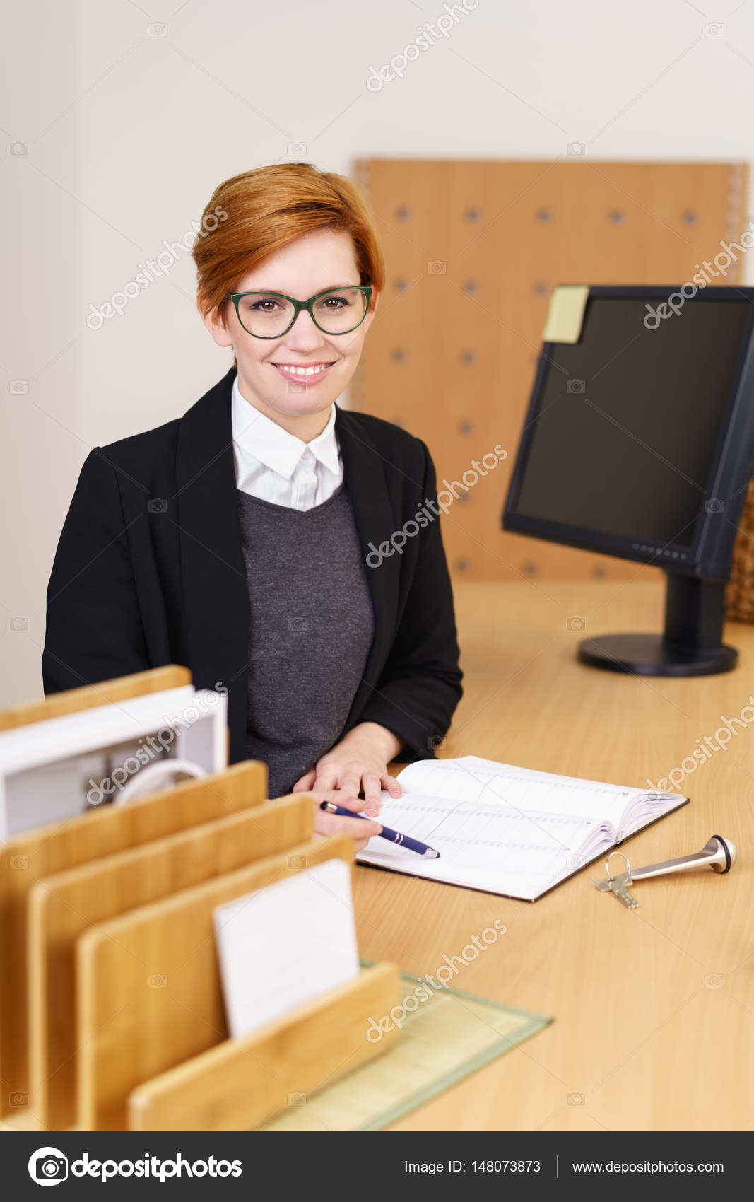 Attractive hotel receptionist Stock Photo by ©racorn 148073873