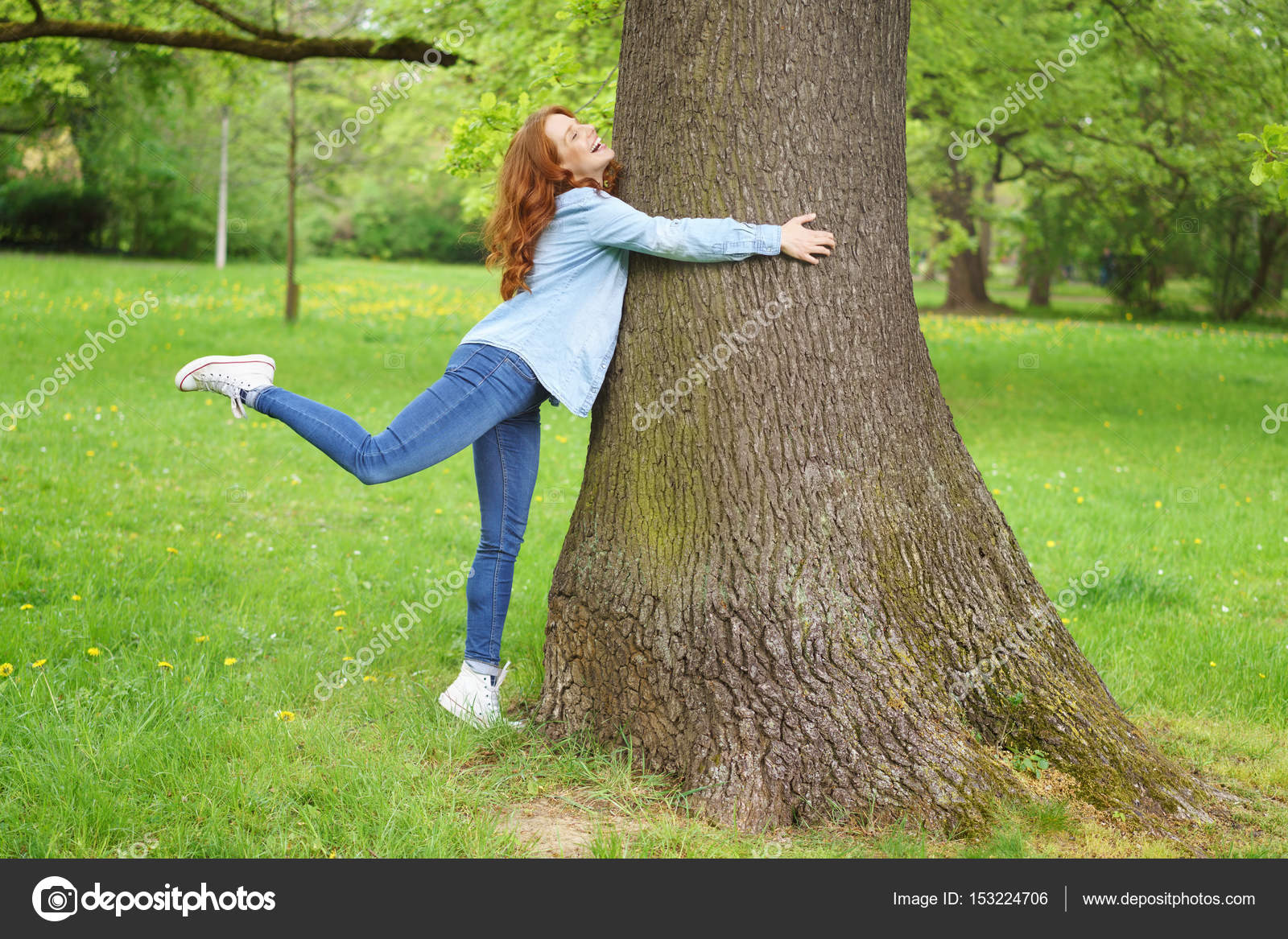 Demonstrative young woman hugging a tree Stock Photo by ©racorn 153224706